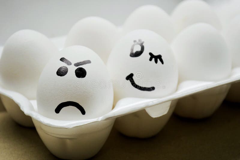 White Eggs with Painted Smiling and Angry Faces in a Tray Stock Image ...