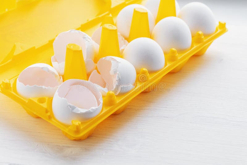 White Eggs Whole and Eggshell. Eggs in a Yellow Box Stock Photo - Image ...