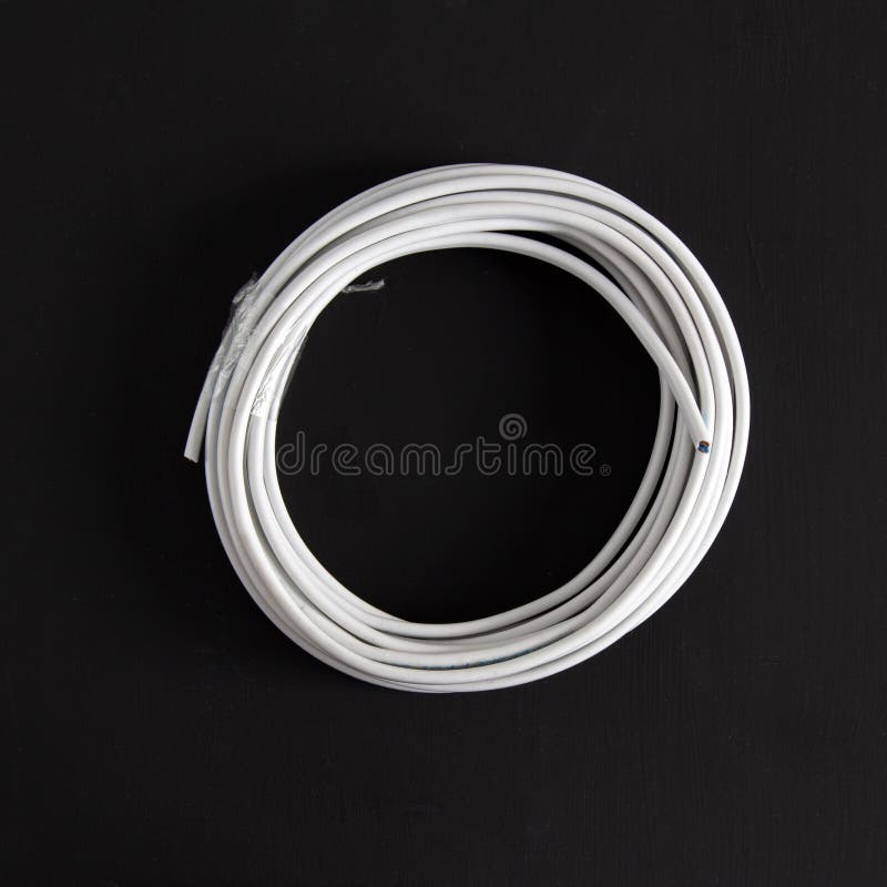 White Electric Cable Rolled into a Circle on a Black Background Stock ...