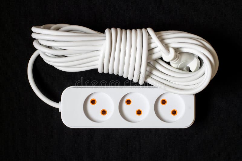 Electric Extension Cord with Plug Inserted into it from Which Grass and ...