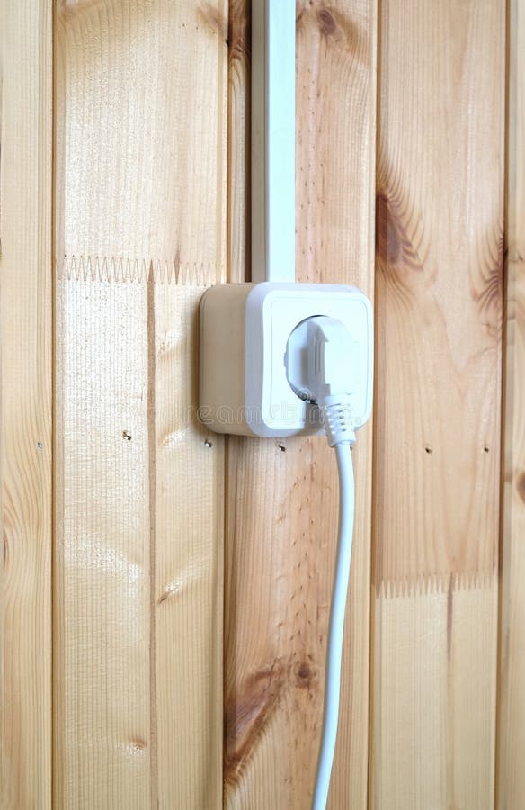 White Electric Plug in Socket on Wooden Wall with Vertical Planks Stock ...
