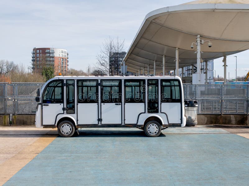 White Electric Shuttle Bus is Parked at a Modern Tram Transit Station ...