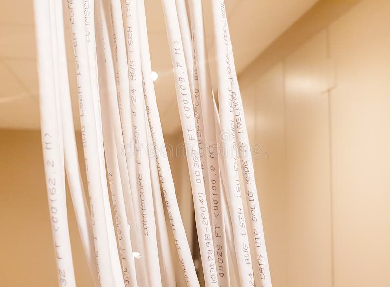 White Electrical Cables in the Foreground Hanging Vertically from the ...