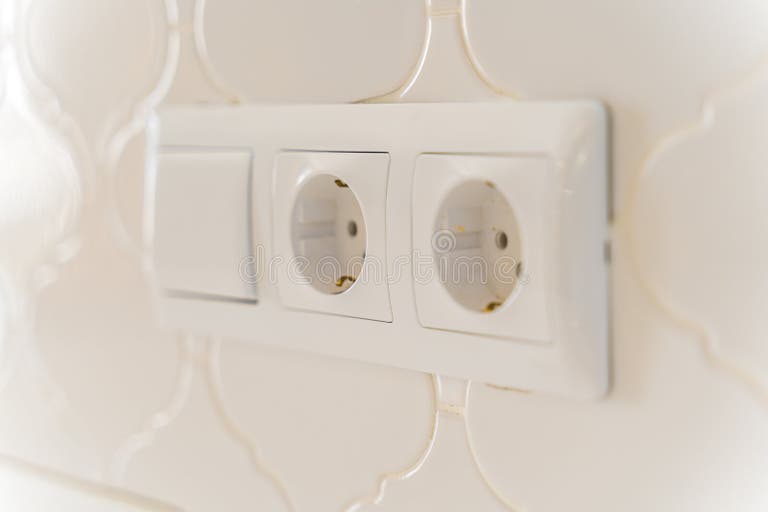 A White Electrical Outlet with Three Outlets on it Stock Photo - Image ...