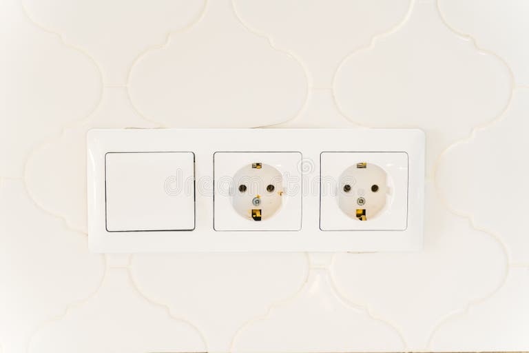 A White Electrical Outlet with Three Outlets on it Stock Photo - Image ...