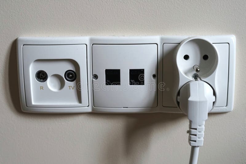 A White Electrical Outlet on the Wall in the Room. an Electric Plug ...