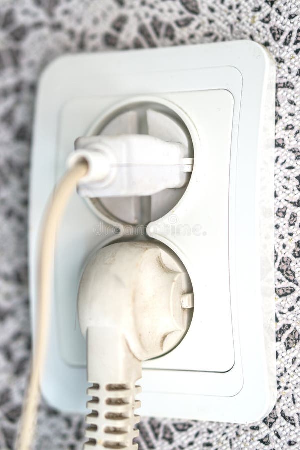 White Electrical Plug in the Electric Socket on Wall. Connected Ac ...