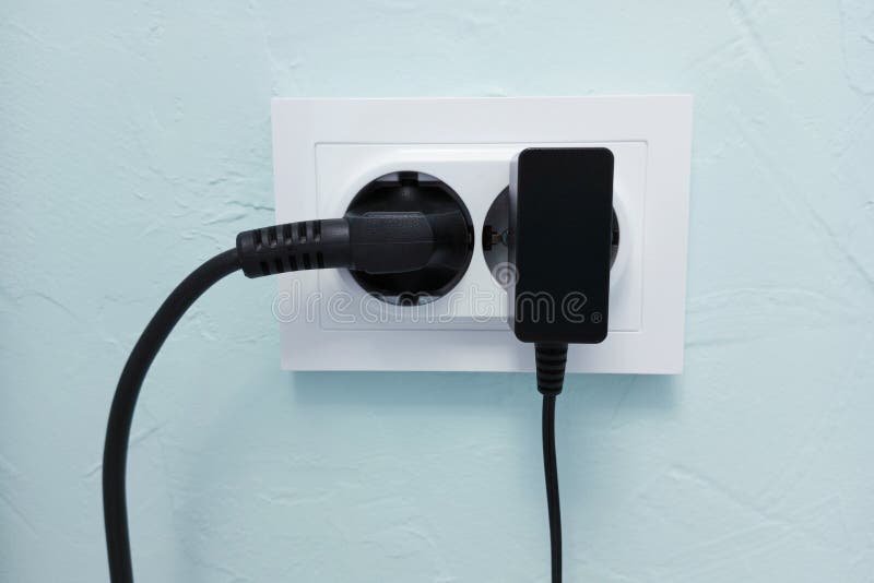 White Electrical Socket on Wall with Electrical Appliances Turned on ...