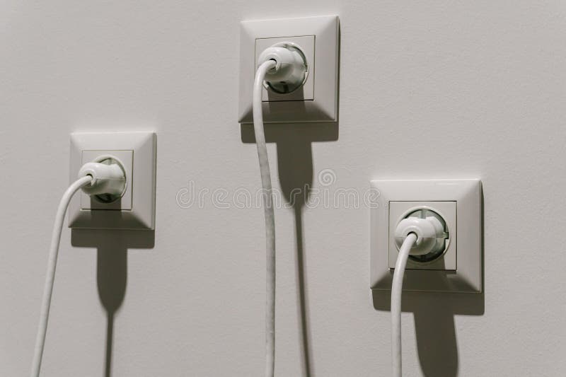 White Electrical Sockets with Plugs in Them. Connecting High-voltage ...