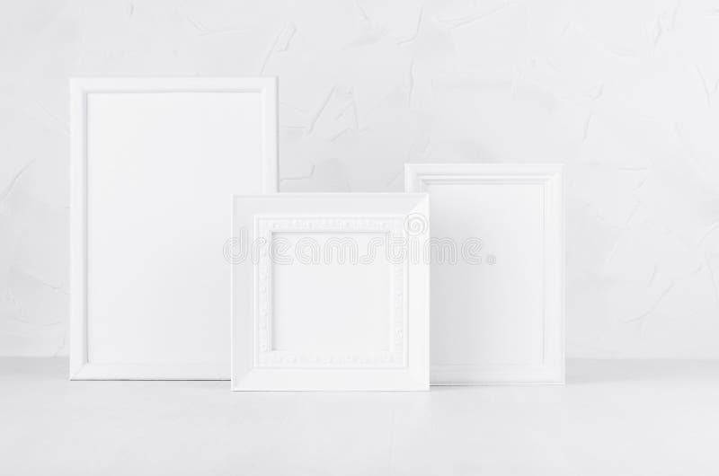 White Empty Different Photo Frames Standing on White Wood Table in ...