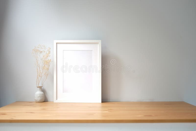 White Empty Picture Frame and Potted Plant on Wooden Table Stock Image ...