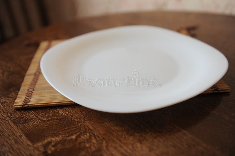 White Empty Plate on a Mat on the Wooden Table Textural Stock Image ...