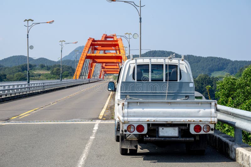 White Empty Small Lorry Park on the Side Way of Orange Hanging Bridge ...