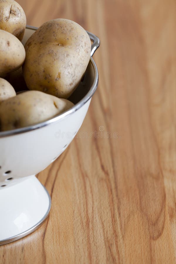 White Enamel Colander with Raw Potatoes As a Detail View Stock Photo ...