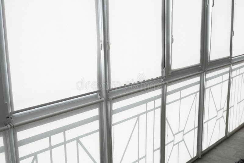 White Fabric Roller Blinds On The Plastic Window With Wood Texture In ...
