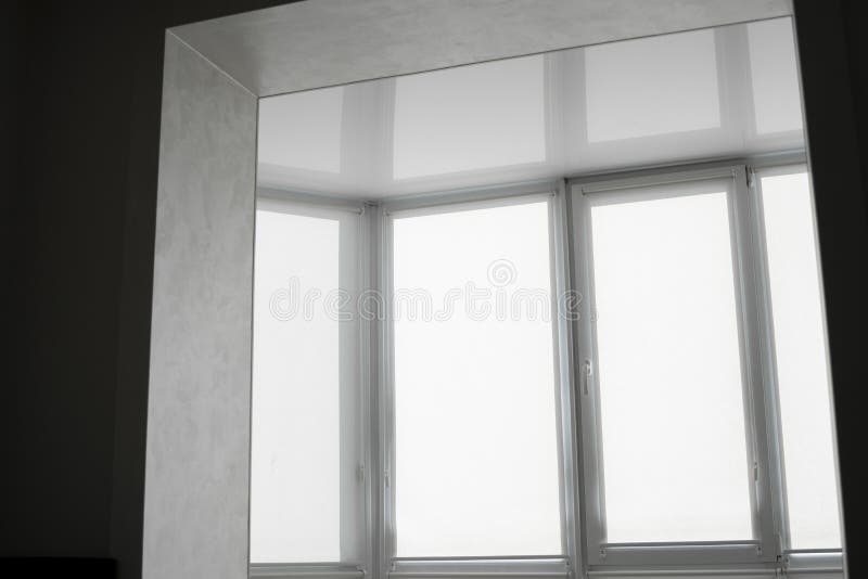 White Fabric Roller Blinds on the Plastic Window on a Balcony in the ...