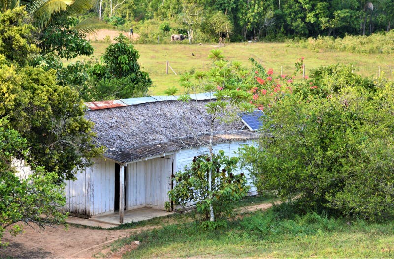 A White Farm Hut with a Solar Panel on Its Rooftop. Renewable Energy in ...