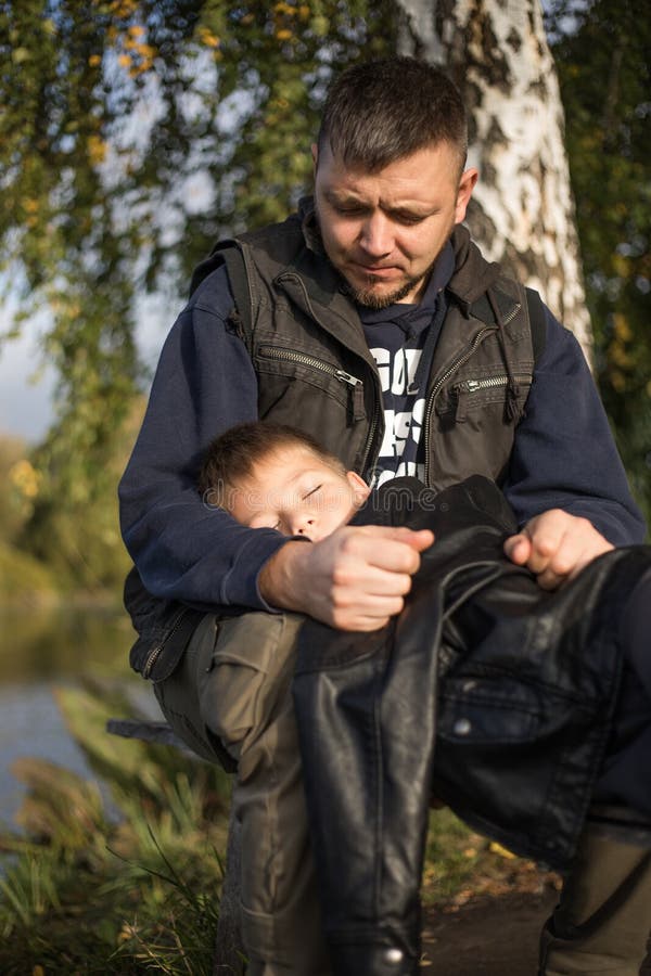 White Father Smiling while Walking with Her Sleeping Son Outdoor Stock ...