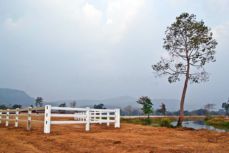 White Fence in Farm Field and Overcast Sky Stock Photo - Image of ...