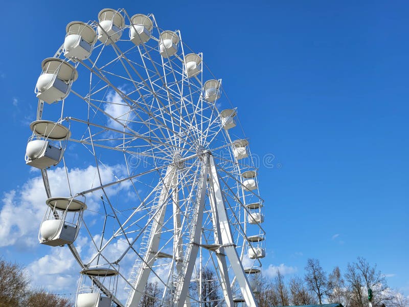A White Ferris Wheel Against a Blue Sky Background. Stock Photo - Image ...