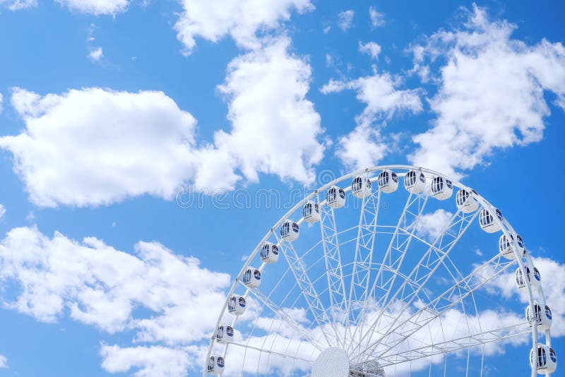 White Ferris Wheel with Glass Light Blue Cabins Against Blue Sky, Dubai ...