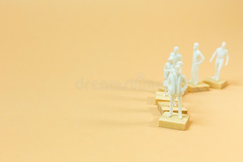 White Figure Miniature on Orange Pastel for Business Content Stock ...