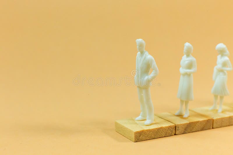 White Figure Miniature on Orange Pastel for Business Content Stock ...