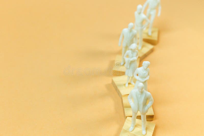White Figure Miniature on Orange Pastel for Business Content Stock ...