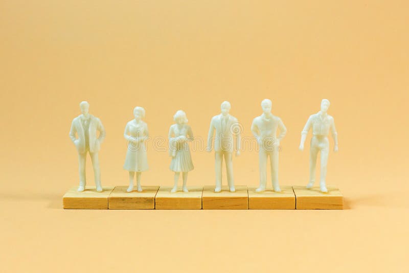 White Figure Miniature on Orange Pastel for Business Content Stock ...