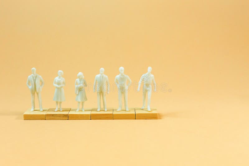 White Figure Miniature on Orange Pastel for Business Content Stock ...