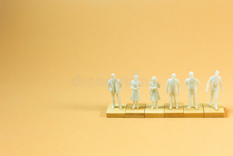 White Figure Miniature on Orange Pastel for Business Content Stock ...
