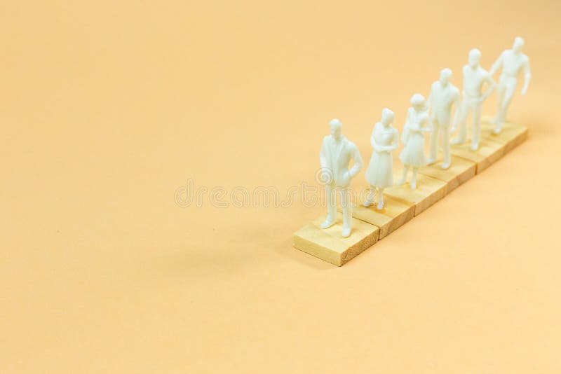 White Figure Miniature on Orange Pastel for Business Content Stock ...