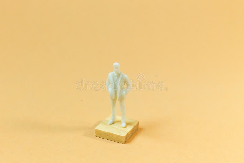 White Figure Miniature on Orange Pastel for Business Content Stock ...