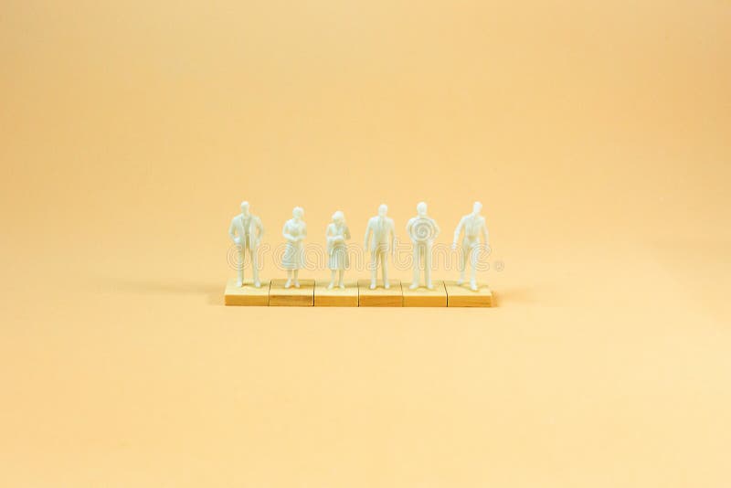 White Figure Miniature on Orange Pastel for Business Content Stock ...