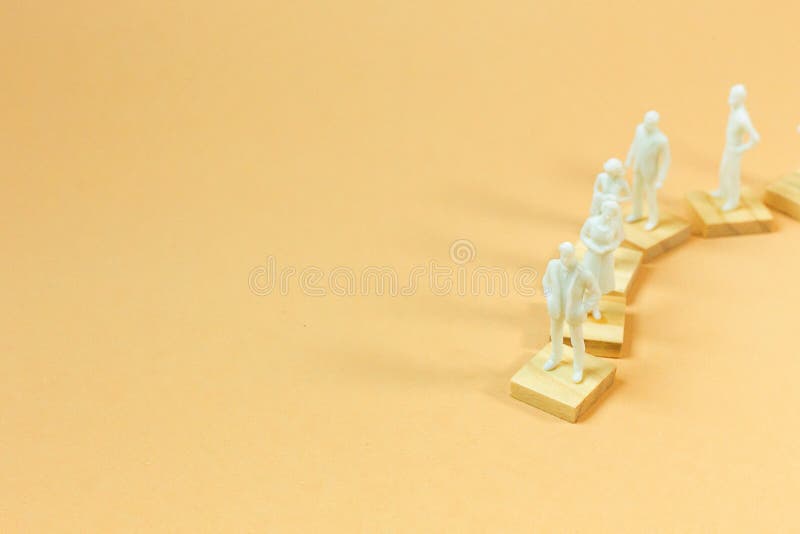 White Figure Miniature on Orange Pastel for Business Content Stock ...