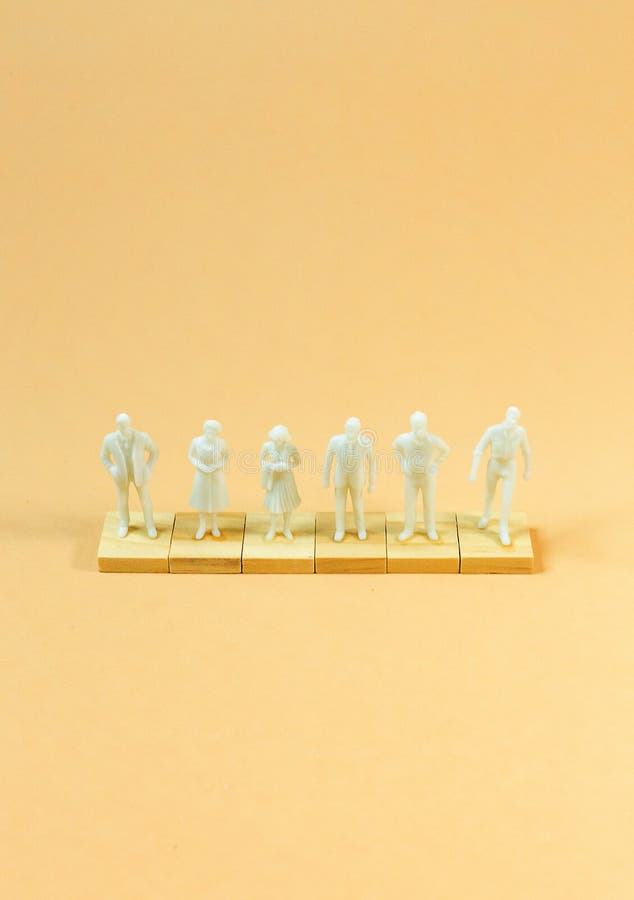 White Figure Miniature on Orange Pastel for Business Content Stock ...