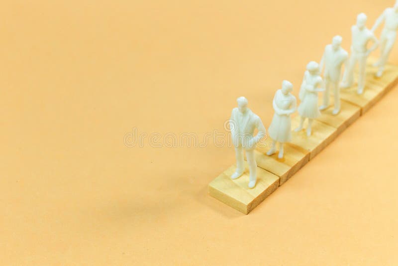 White Figure Miniature on Orange Pastel for Business Content Stock ...
