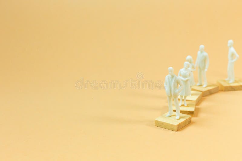 White Figure Miniature on Orange Pastel for Business Content Stock ...