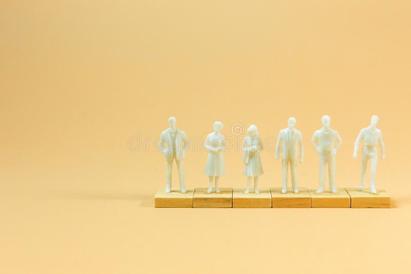White Figure Miniature on Orange Pastel for Business Content Stock ...