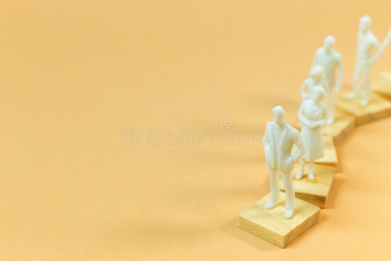 White Figure Miniature on Orange Pastel for Business Content Stock ...