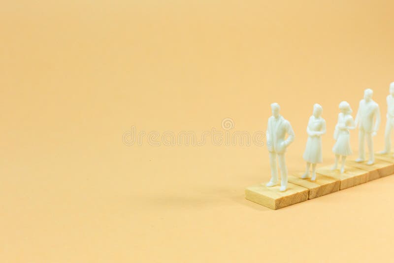 White Figure Miniature on Orange Pastel for Business Content Stock ...