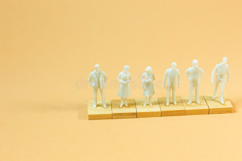 White Figure Miniature on Orange Pastel for Business Content Stock ...