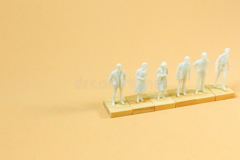 White Figure Miniature on Orange Pastel for Business Content Stock ...