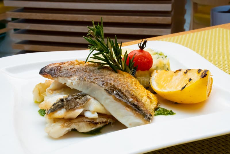 White Fish Fillet with Puree Served with Lemon and Rosemary in a White ...