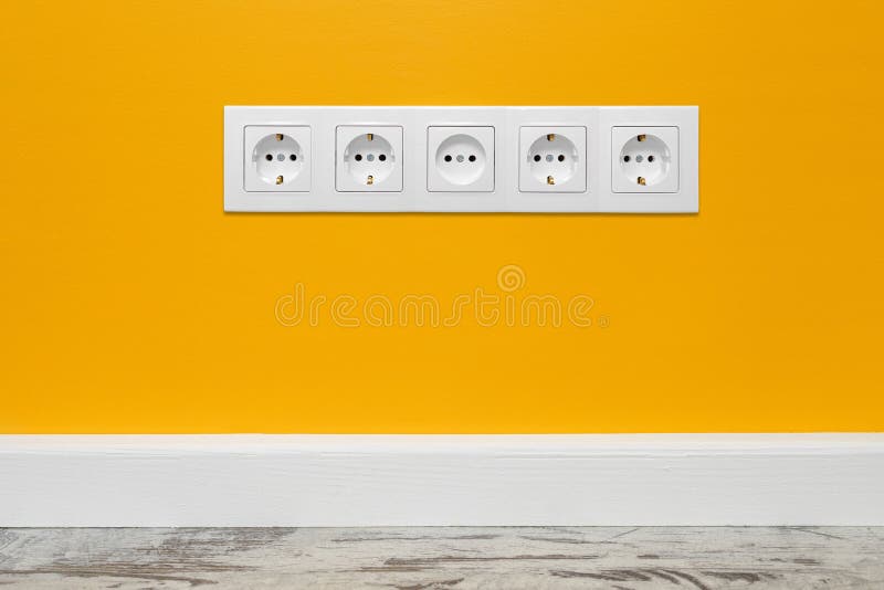 White Five-way Wall Power Socket on Yellow Wall Stock Image - Image of ...