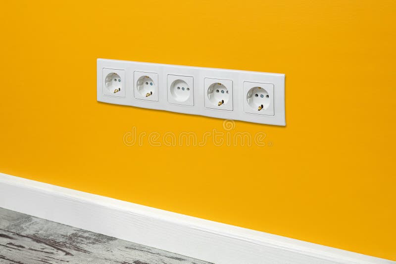 White Five-way Wall Power Socket on the Yellow Wall Stock Image - Image ...