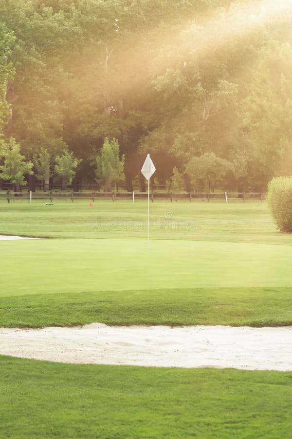White Flag on Golf Course with Sun Rays Stock Photo - Image of golf ...