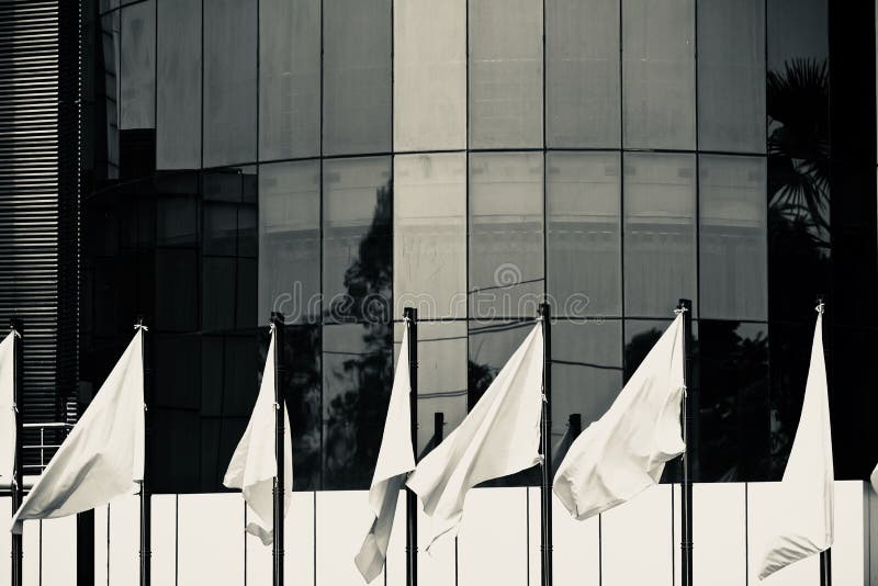 White Flags in Front of a Modern Architectural Building Photograph ...