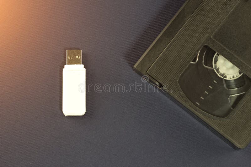 A White Flash Drive on a Blue Background and a Video Cassette, Usb ...