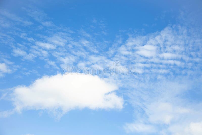 A White Fluffy Cloud with Cloudy Ripples in the Blue Sky. Stock Photo ...